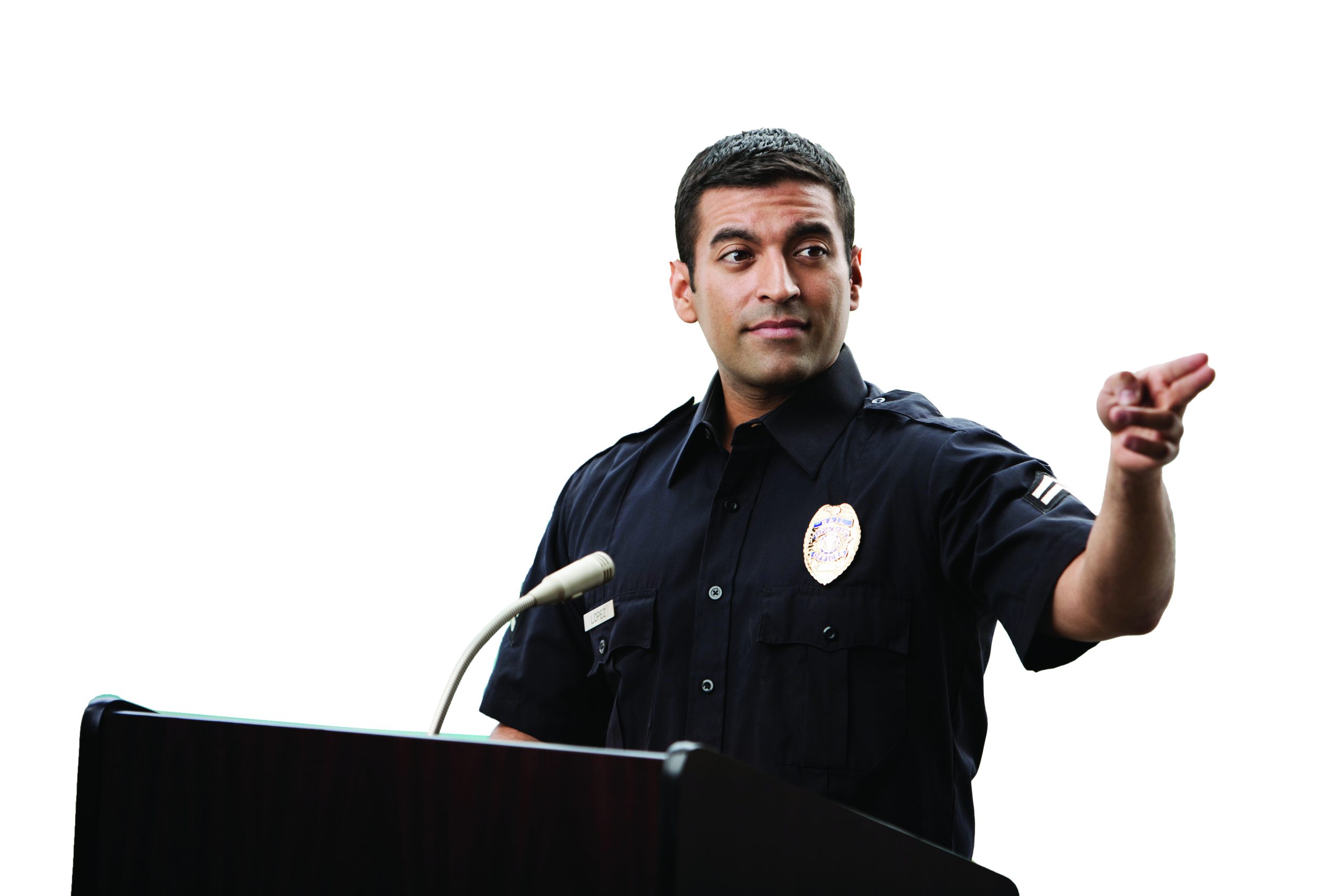 Hispanic policeman standing at podium - Police Chief Magazine