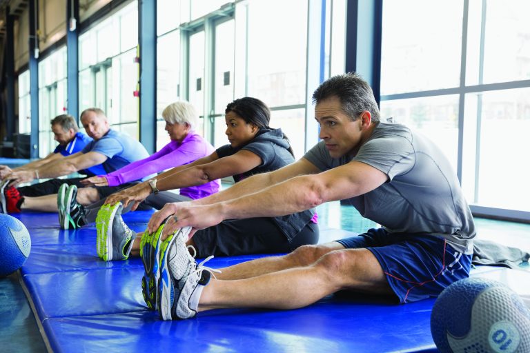 Group stretching in exercise class at gym - Police Chief Magazine